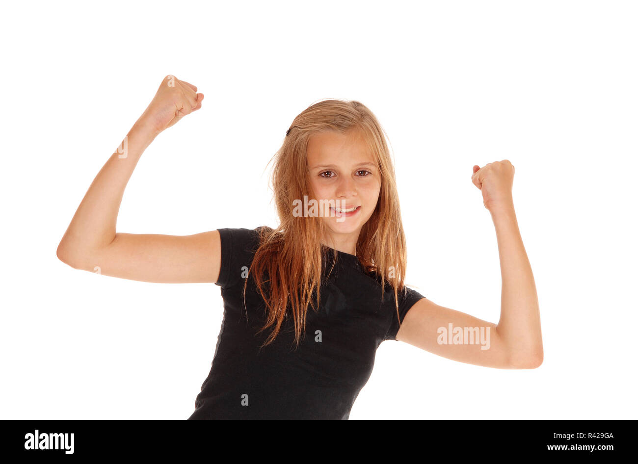 Happy young girl raising her arms Stock Photo - Alamy