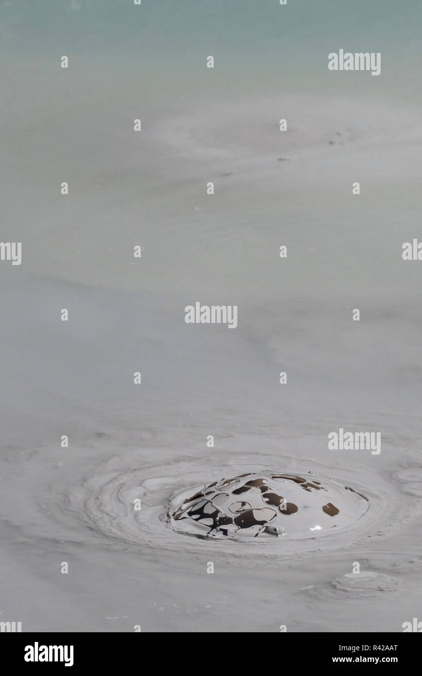USA, Wyoming. Rising bubbles of gas exploding through clay and mineral ...