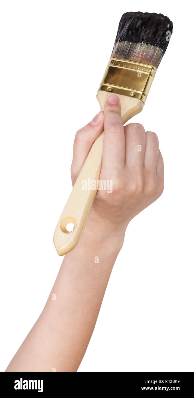 painter hand with flat paint brush paints in black Stock Photo - Alamy