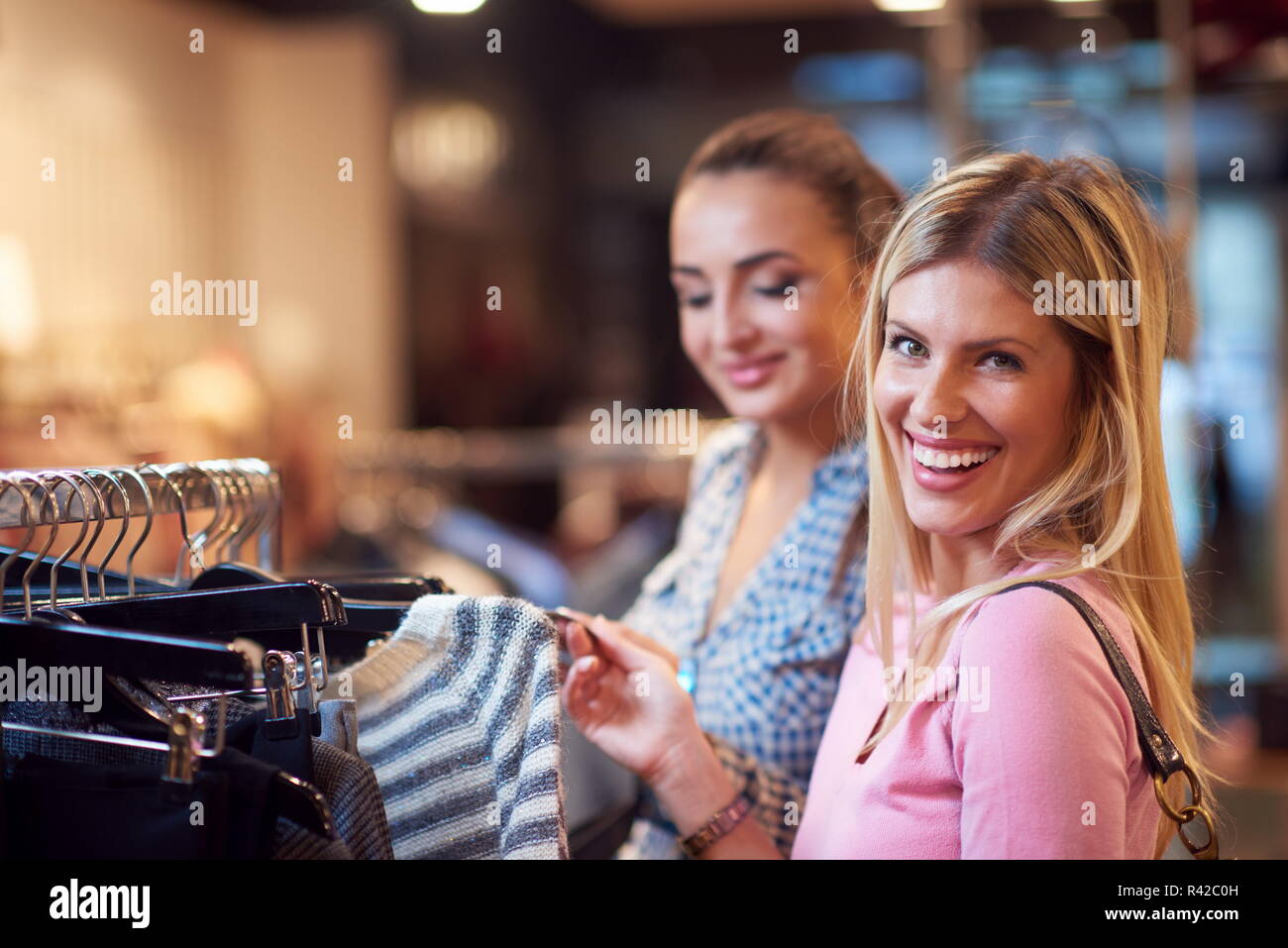 happy young girls in shopping mall Stock Photo - Alamy