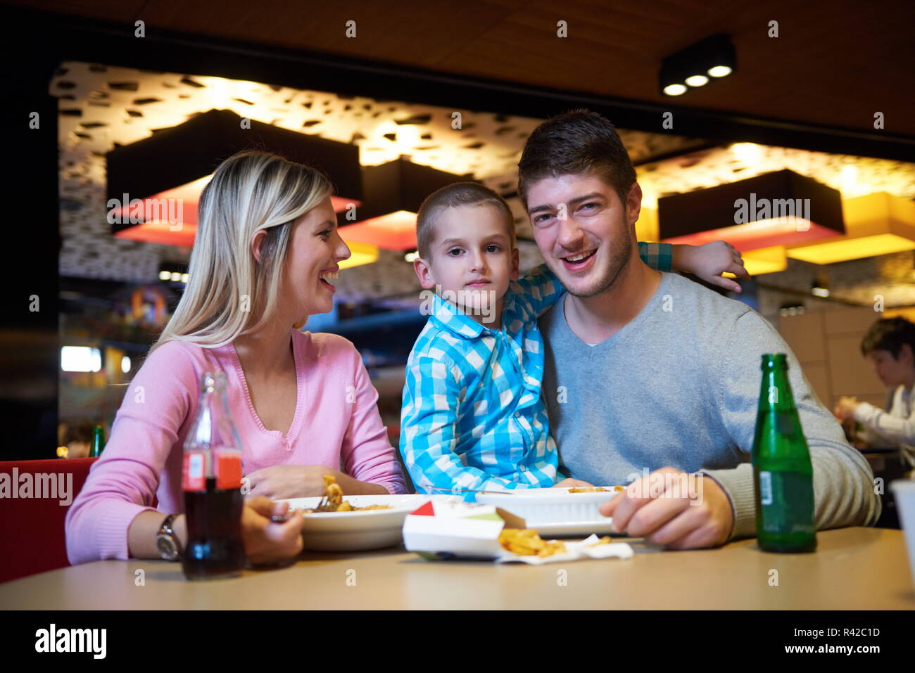 family having lunch in shopping mall Stock Photo - Alamy