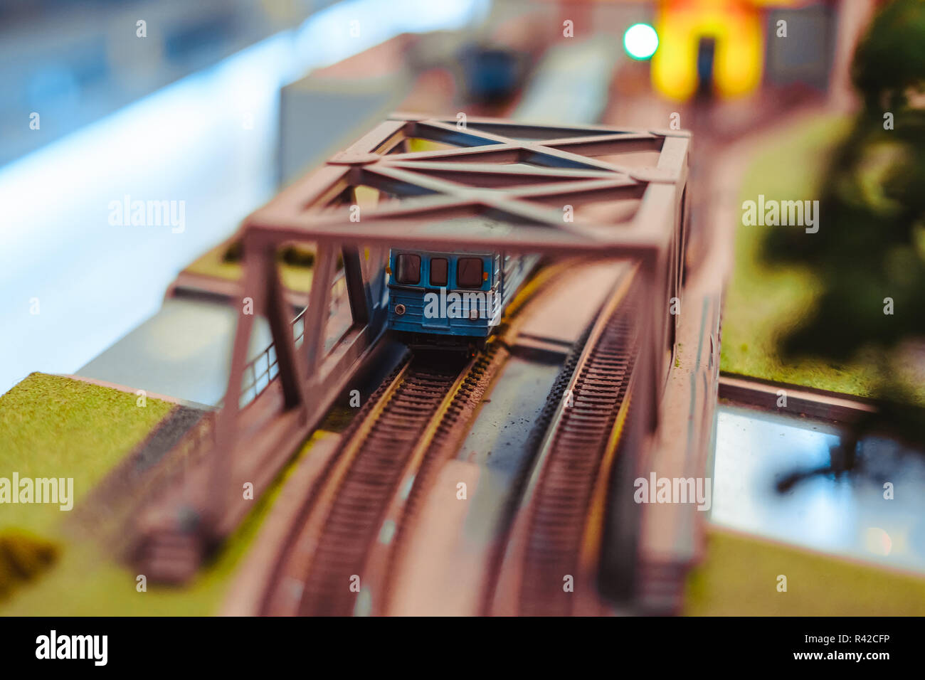 Miniature toy model of modern train crossing bridge Stock Photo - Alamy