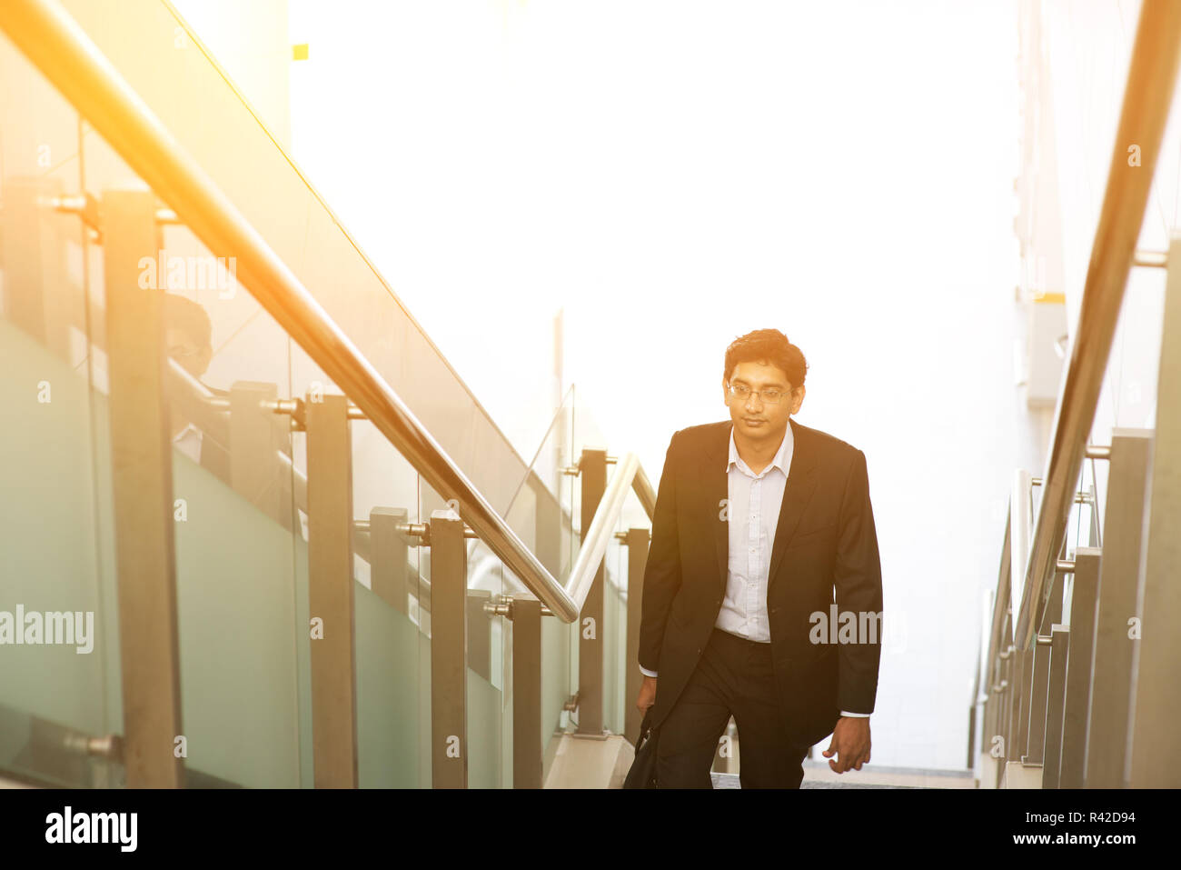 Indian businessman ascending steps Stock Photo - Alamy