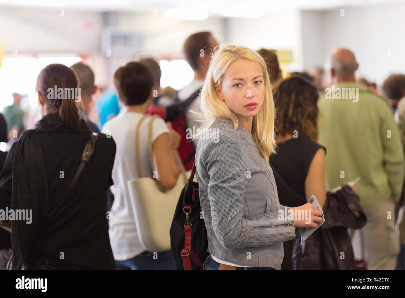 Crowd waiting in line passengers terminal hi-res stock photography and ...