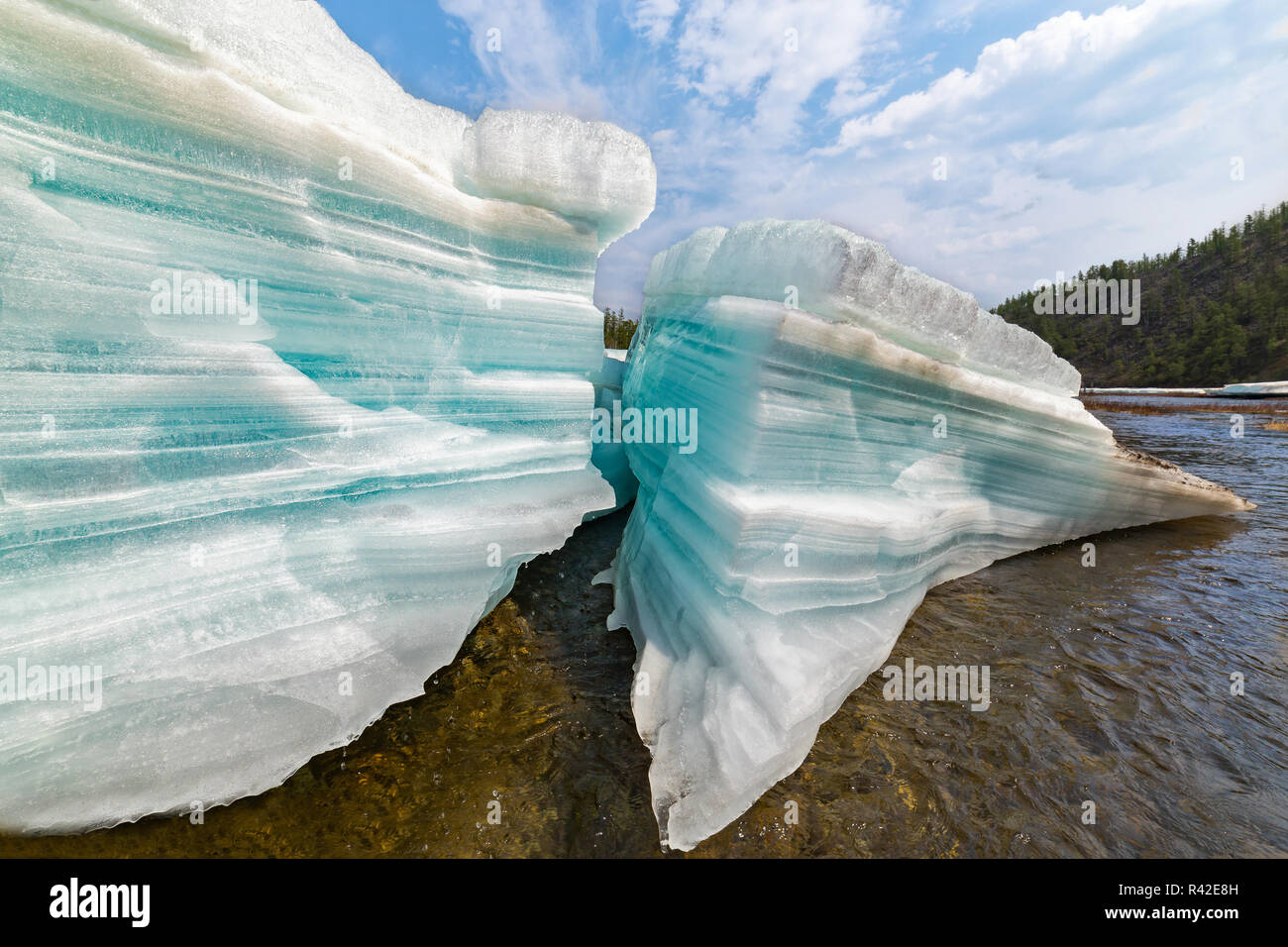Turquoise layered ice on the river in South Yakutia, Russia Stock Photo ...