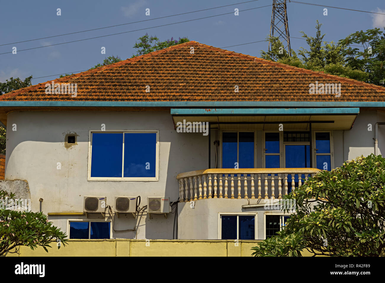 A house with blue windows Stock Photo - Alamy
