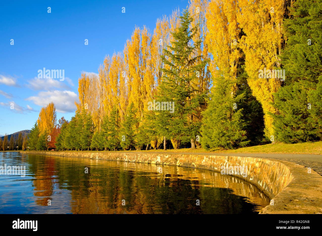 Sunset between red and orange trees on the shores of lake burley ...