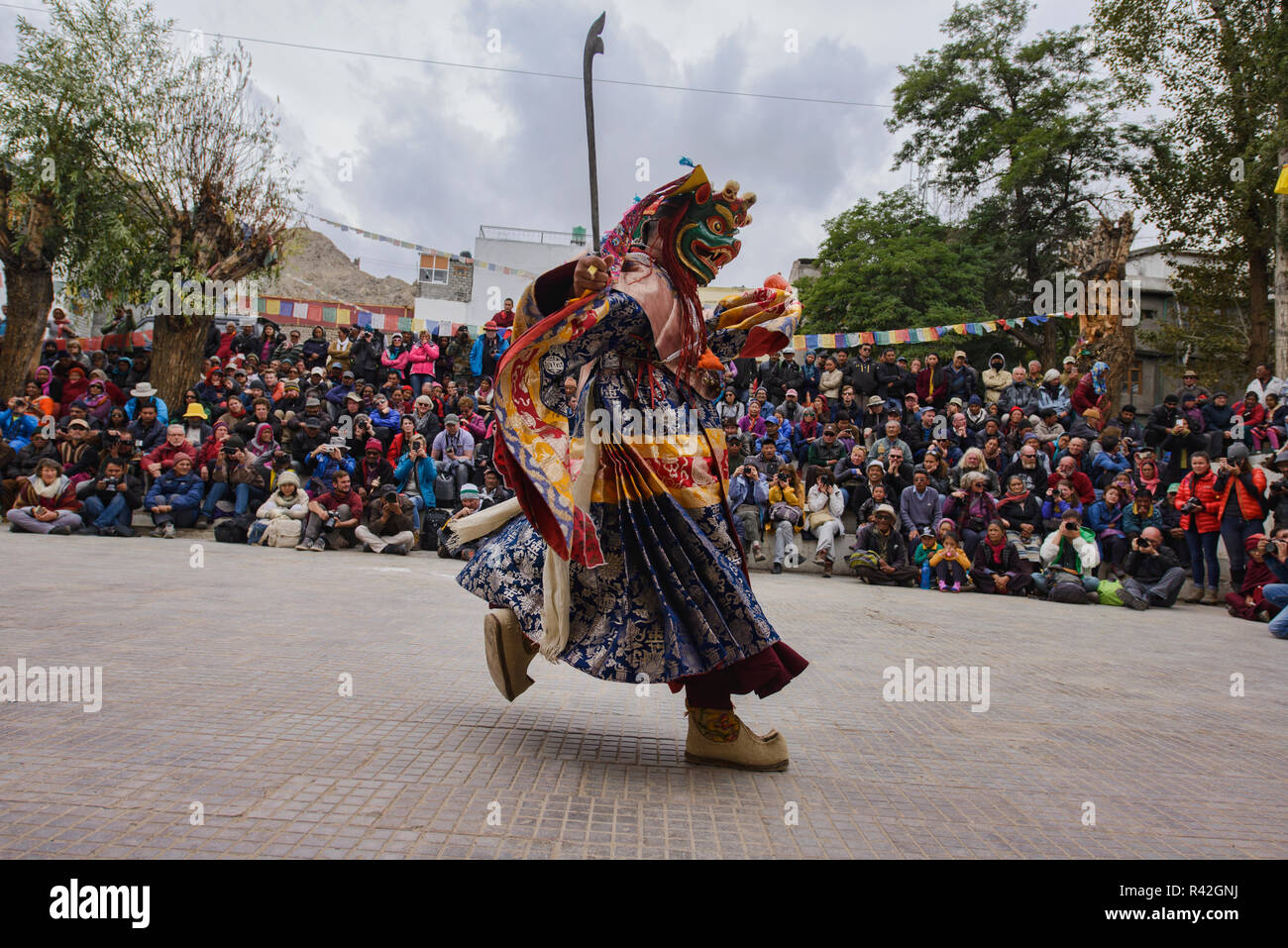 A masked monk performs at a traditional cham Tibetan Buddhist dance ...