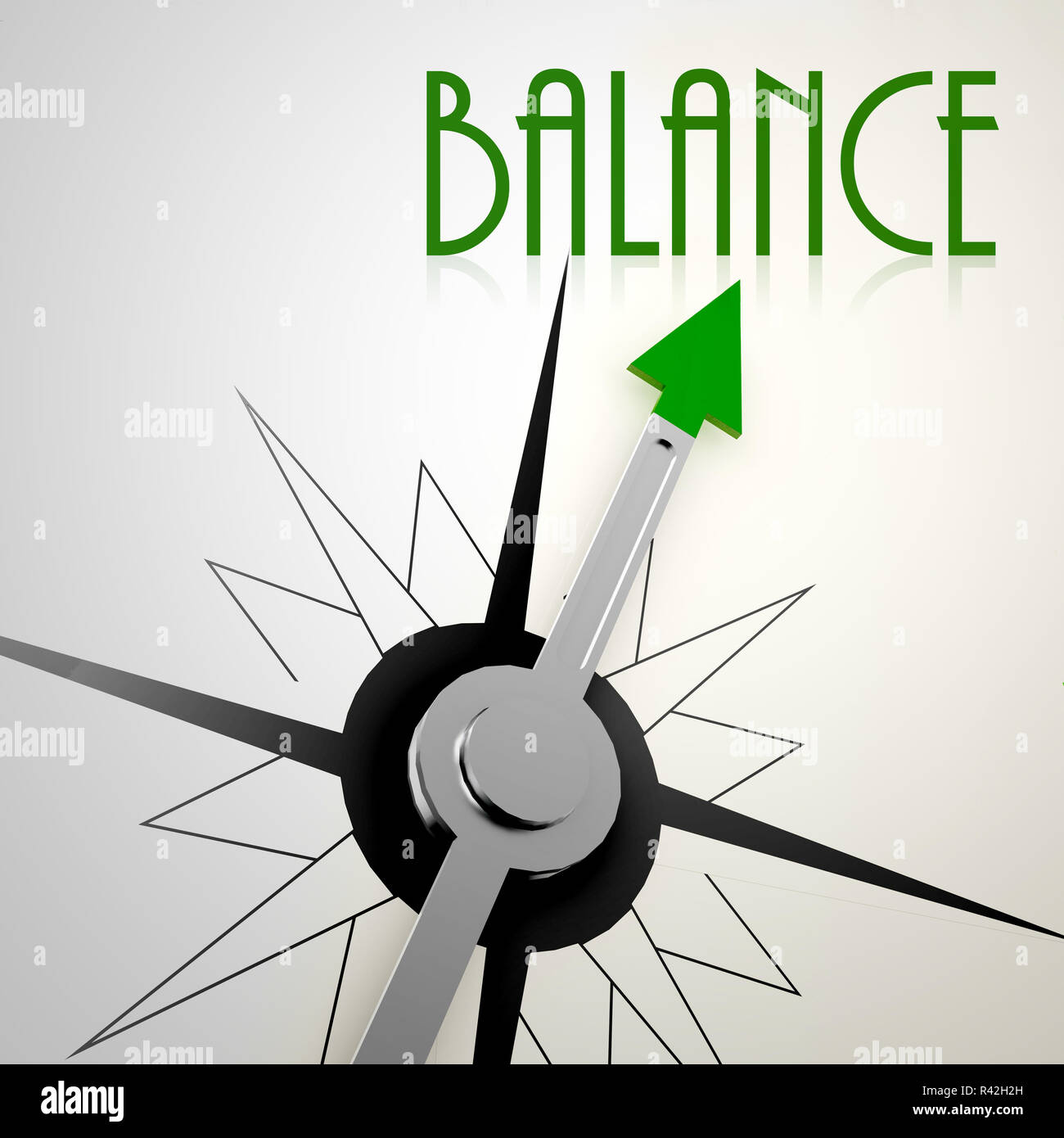 Balance on green compass Stock Photo - Alamy