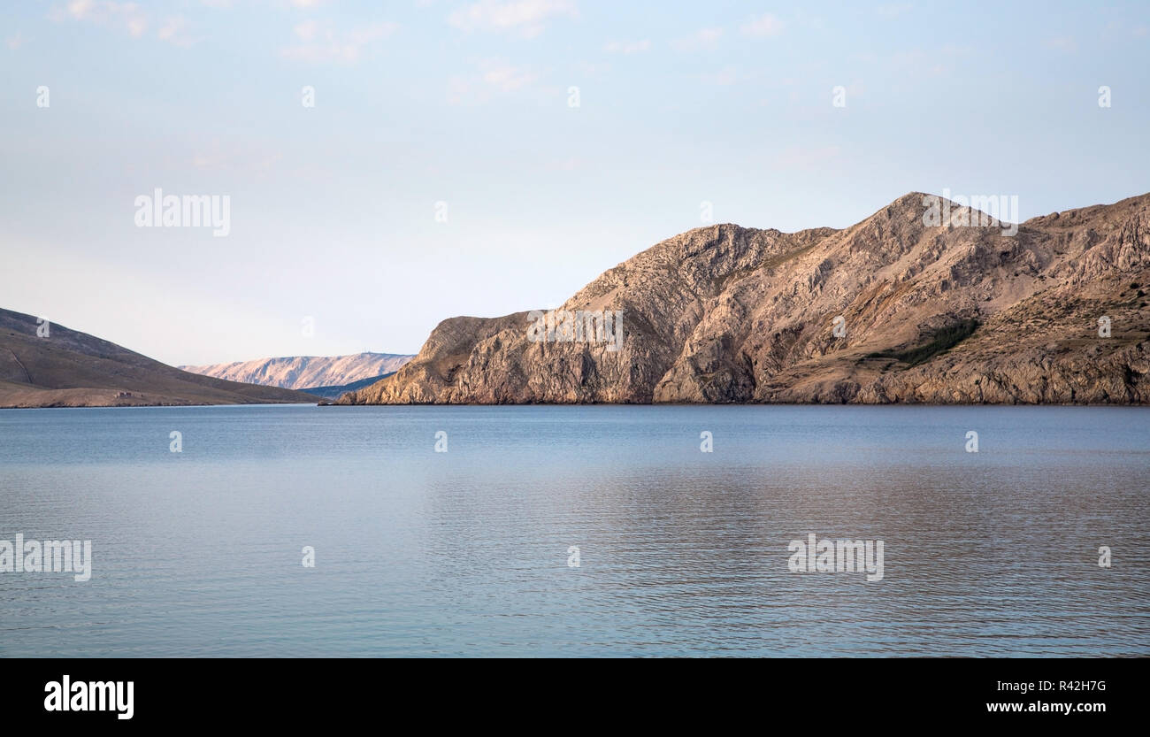 Sea lagoon enclosed by mountains Stock Photo - Alamy