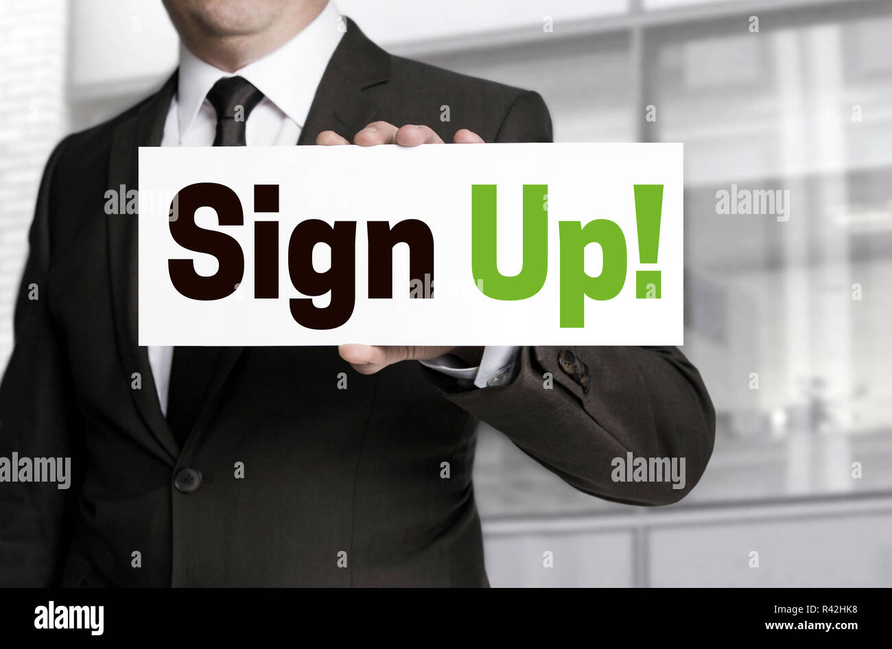 sign up sign held by businessman concept Stock Photo - Alamy
