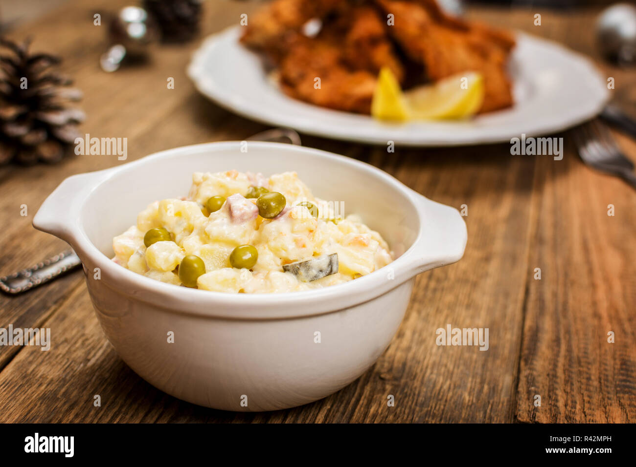 Traditional czech potato salad with mayonnaise and vegetables in white ...