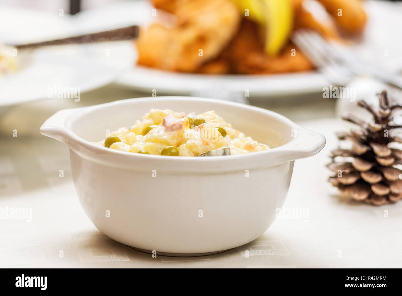 Traditional czech potato salad with mayonnaise and vegetables in white ...