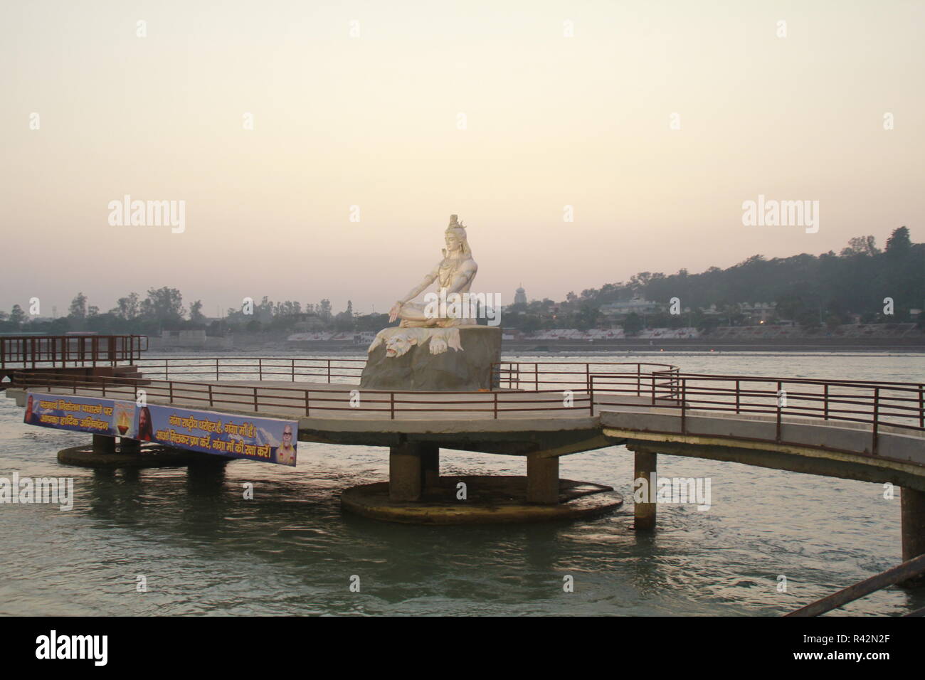 Hindu god Shiva statue at Rishikesh, India. River ganga flows in the ...