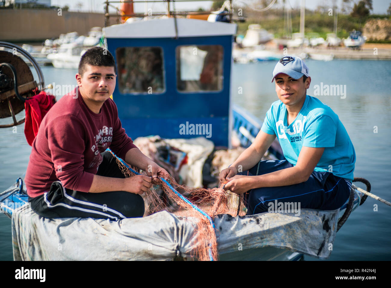 Two young fisherman in the boat, Le Castella, Italy, Europe Stock Photo ...