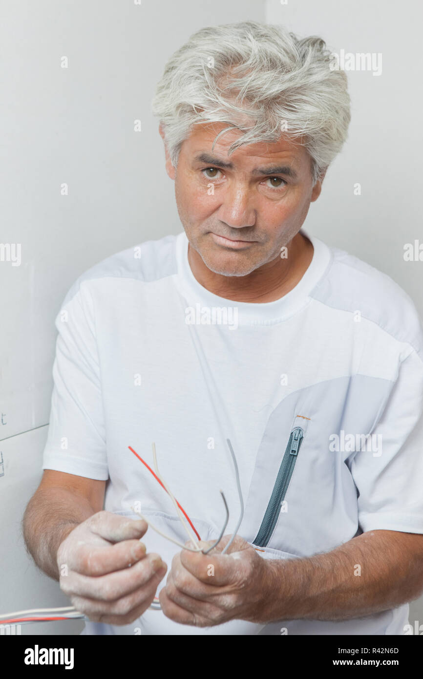Electrician holding cables Stock Photo - Alamy
