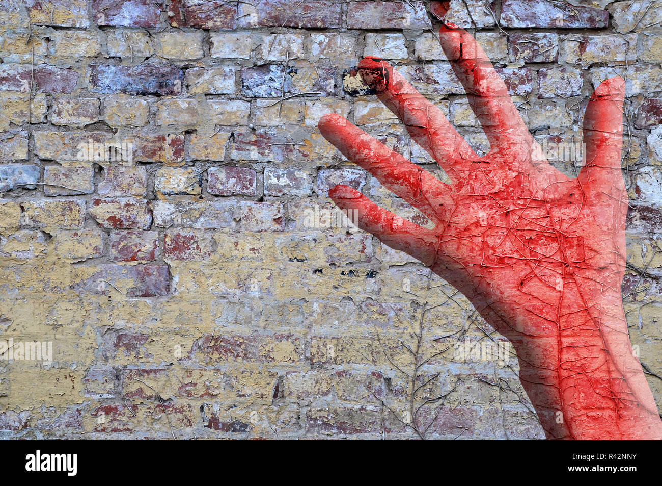 red hand front of old wall Stock Photo - Alamy