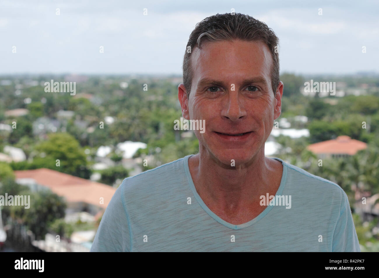 Man light blue shirt smiles hi-res stock photography and images - Alamy