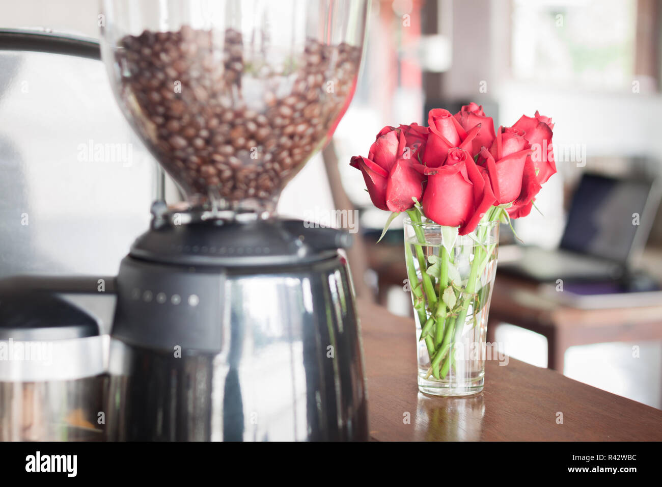 Red roses in coffee shop Stock Photo - Alamy