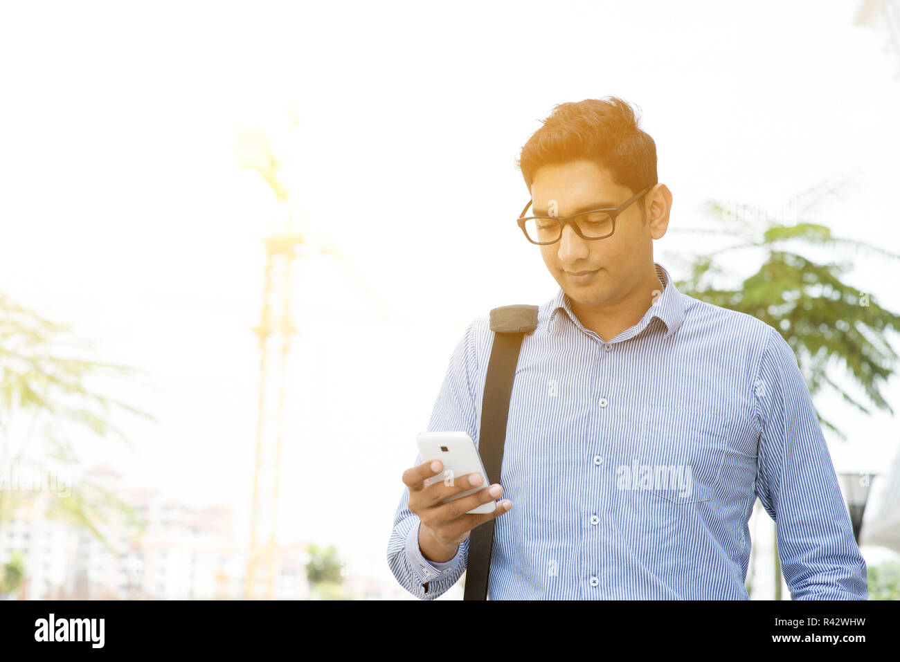Indian business people texting using smartphone Stock Photo - Alamy