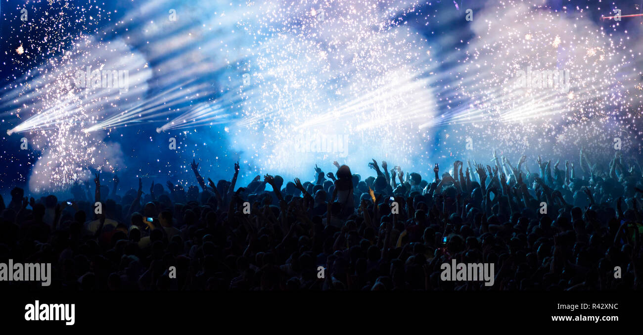 New Year concept - cheering crowd and fireworks Stock Photo - Alamy