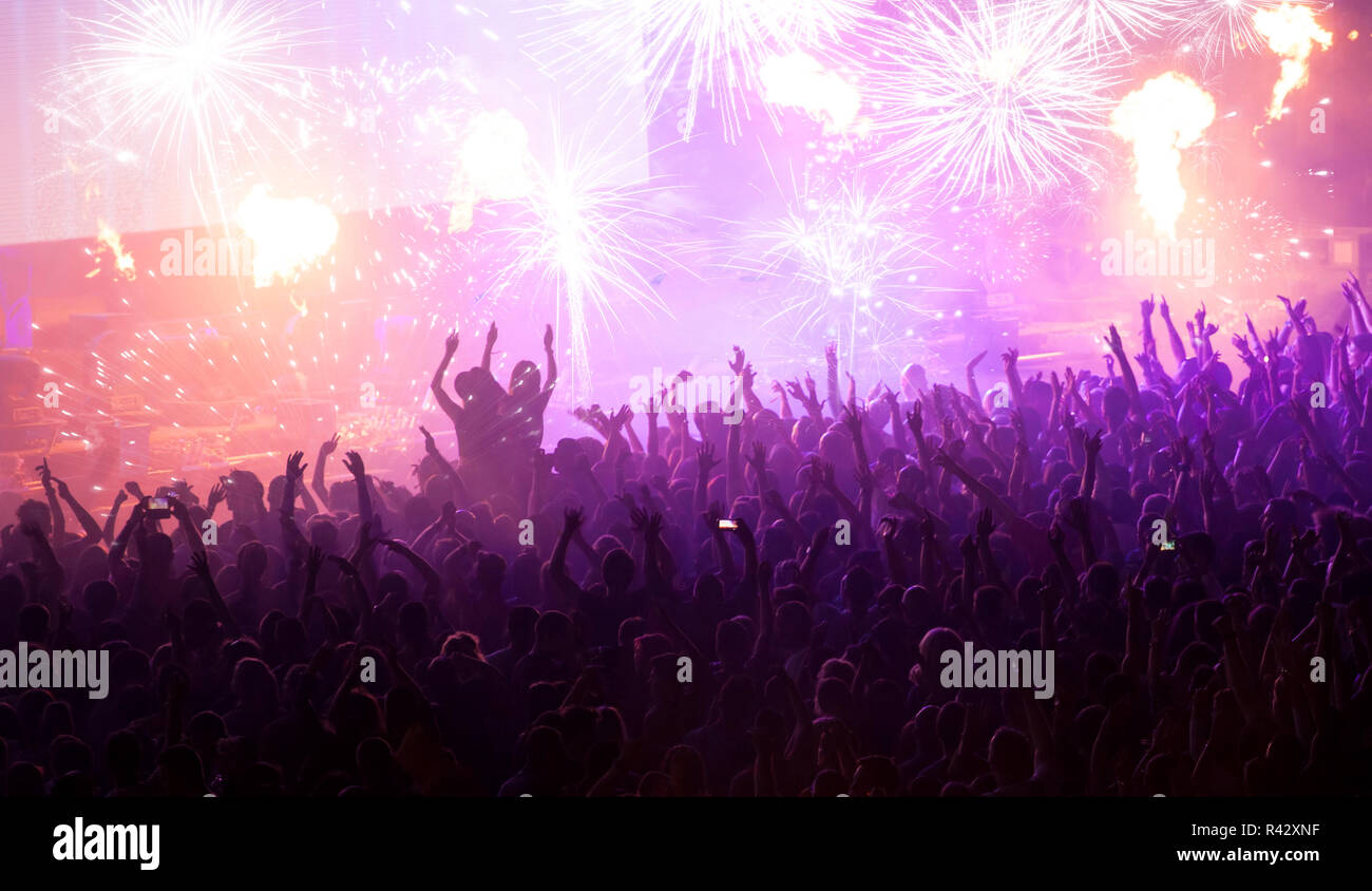 New Year concept - cheering crowd and fireworks Stock Photo - Alamy