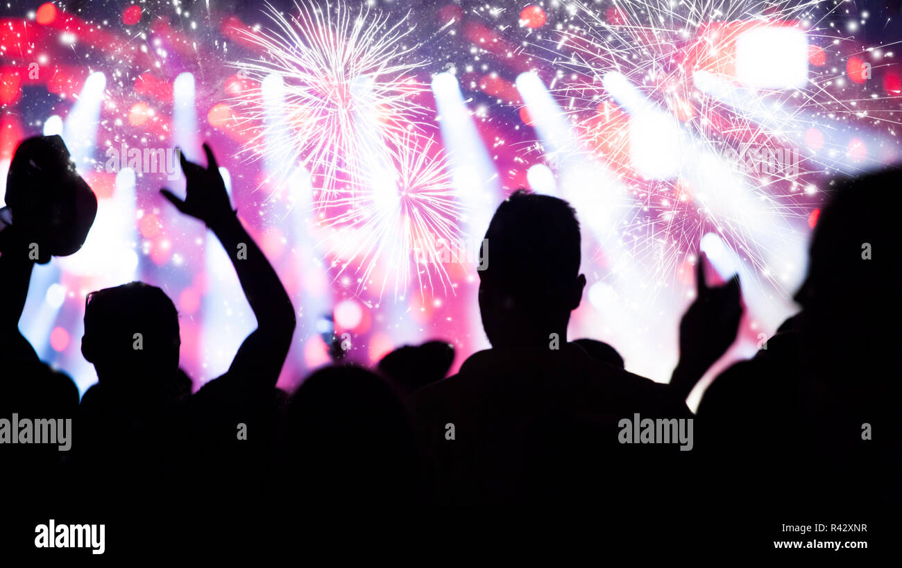 New Year concept - cheering crowd and fireworks Stock Photo - Alamy