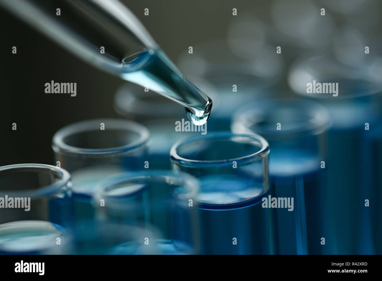 Test tube of glass overflows liquid solution potassium Stock Photo - Alamy