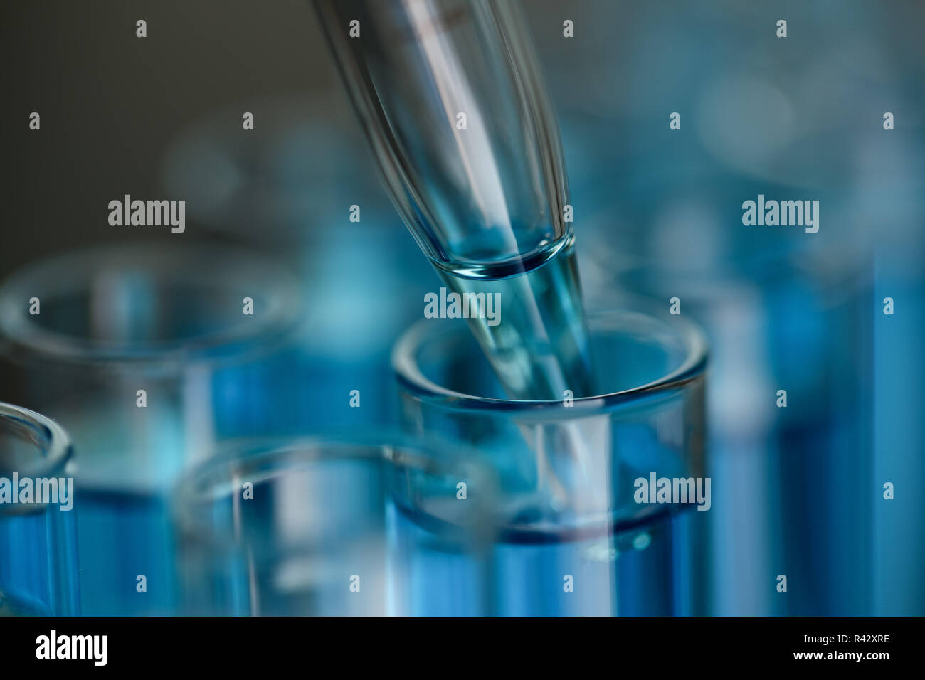 Test tube of glass overflows liquid solution potassium Stock Photo - Alamy