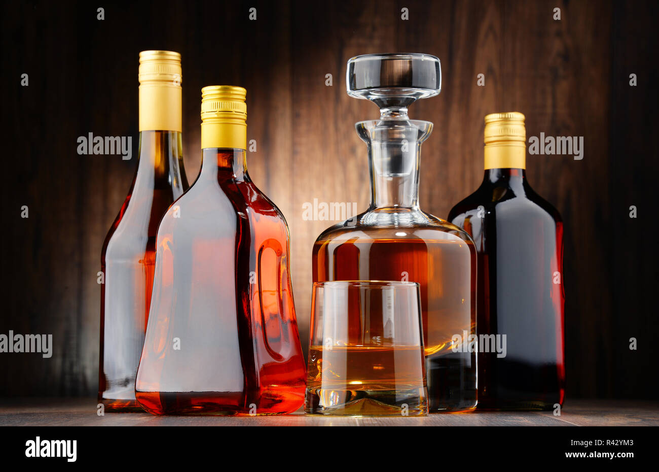 Bottles of assorted alcoholic beverages and glass of whisky Stock Photo ...