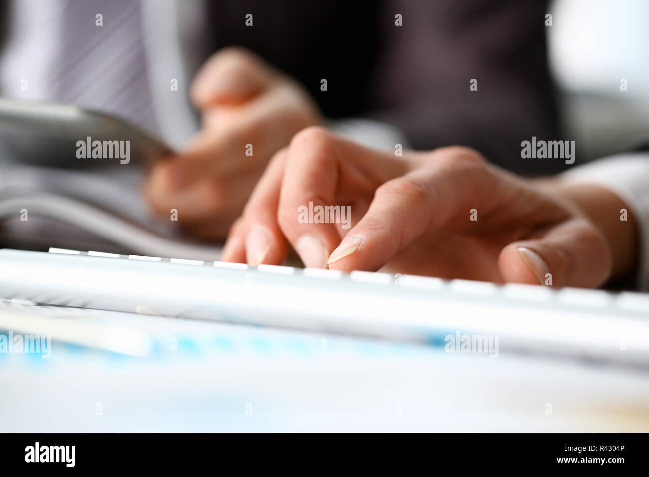 Male arms in suit typing on white Stock Photo - Alamy