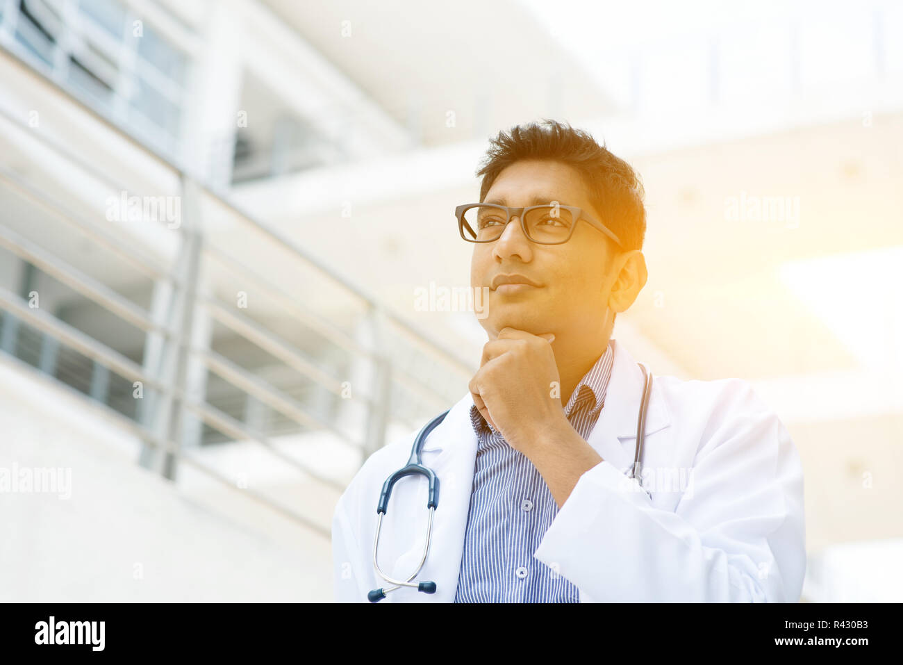 Asian Indian medical doctor thinking Stock Photo - Alamy