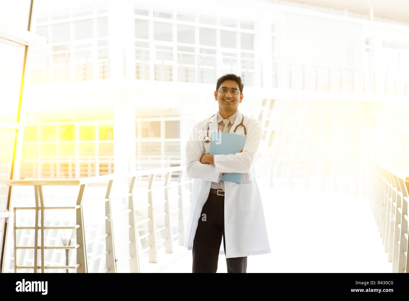 Asian Indian medical doctor holding medical report Stock Photo - Alamy