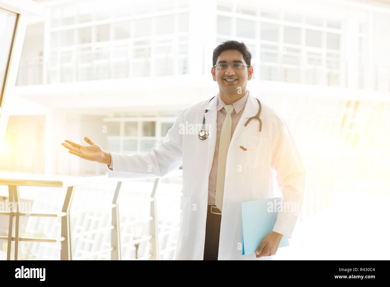 Asian Indian medical doctor welcome hand sign Stock Photo - Alamy