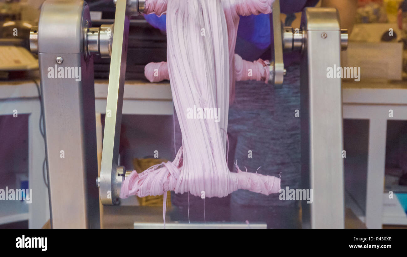 Making purple salt water taffy in small candy shop Stock Photo - Alamy