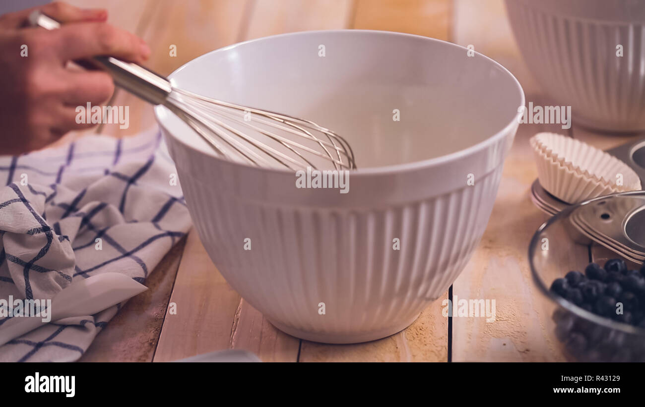 Mixing ingredients together in mixing bowl for blueberry muffins Stock ...