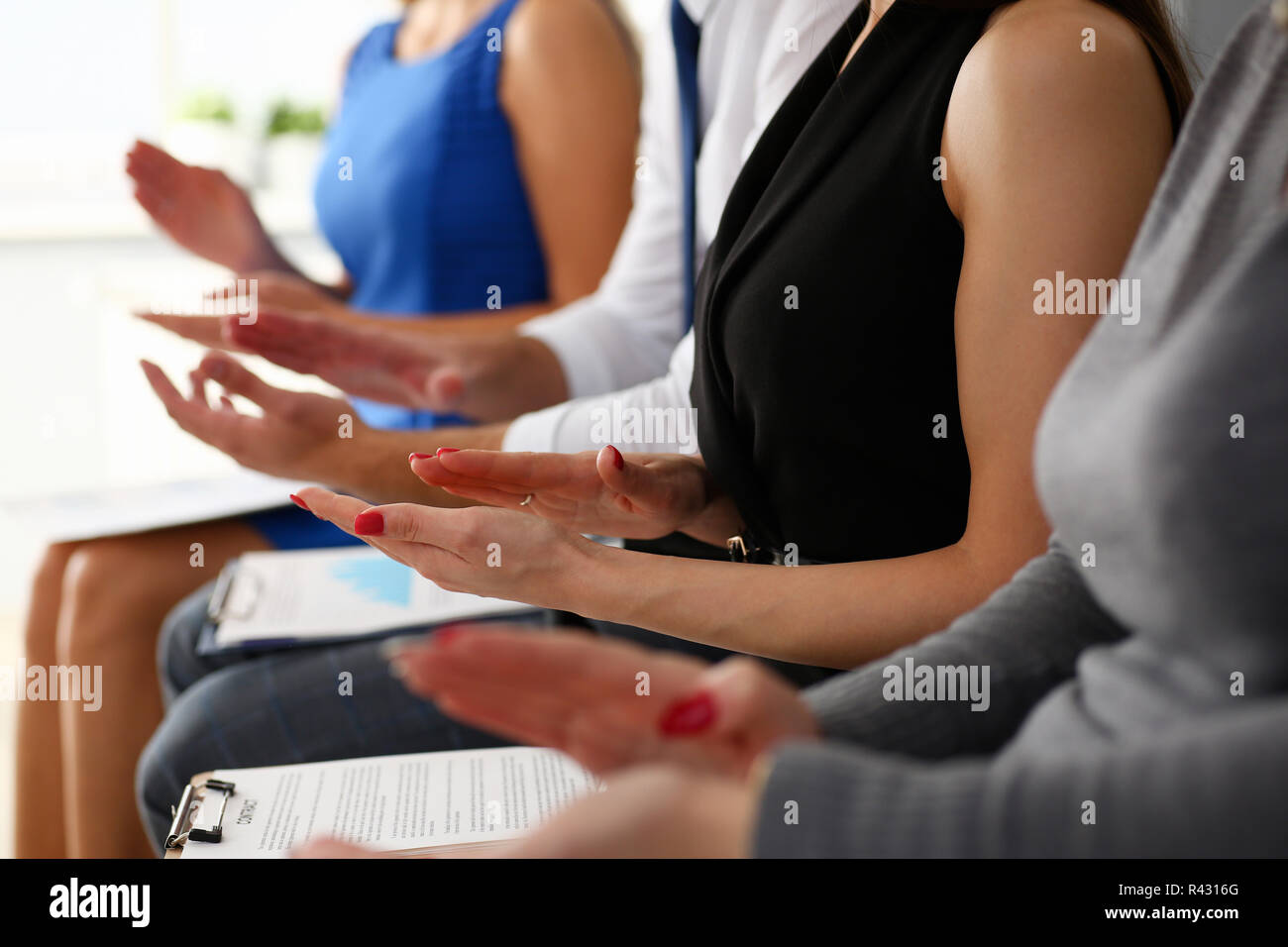 Group of people clap their arm in row Stock Photo - Alamy
