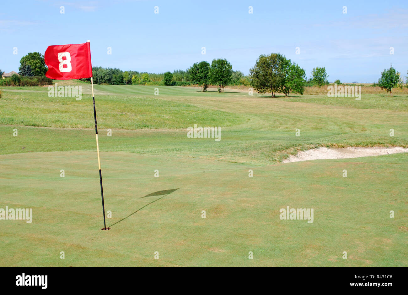 red flag number eight on golf course Stock Photo - Alamy