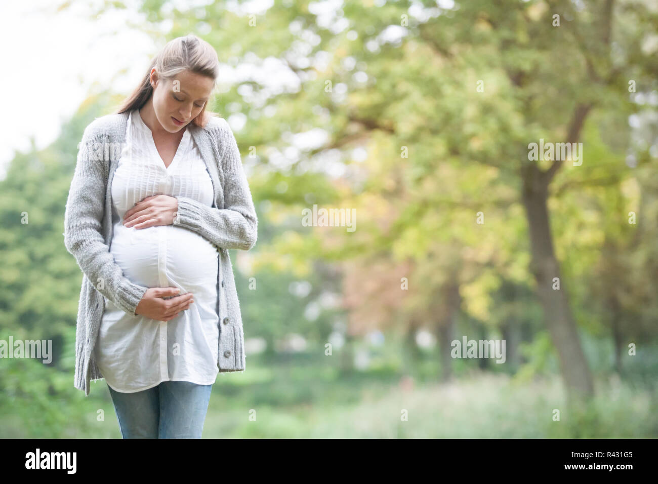 Expecting woman in nature Stock Photo - Alamy