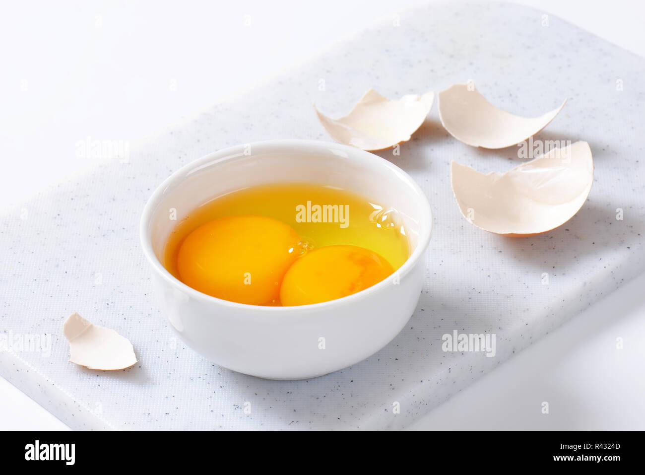 Egg whites and yolks in bowl Stock Photo - Alamy