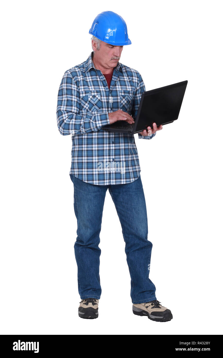 Builder with a laptop Stock Photo - Alamy