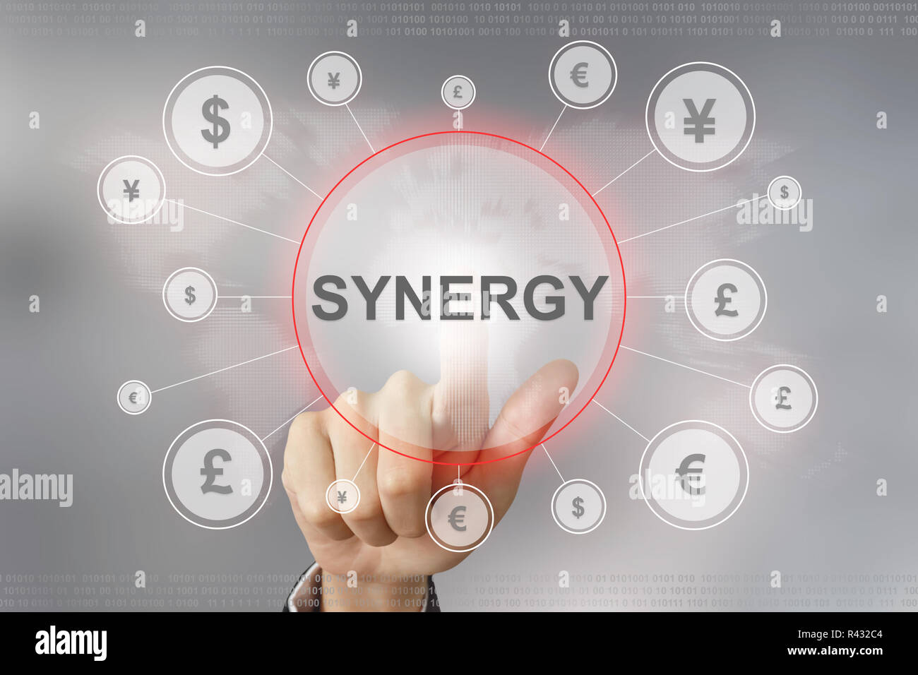 business hand pushing synergy button Stock Photo - Alamy