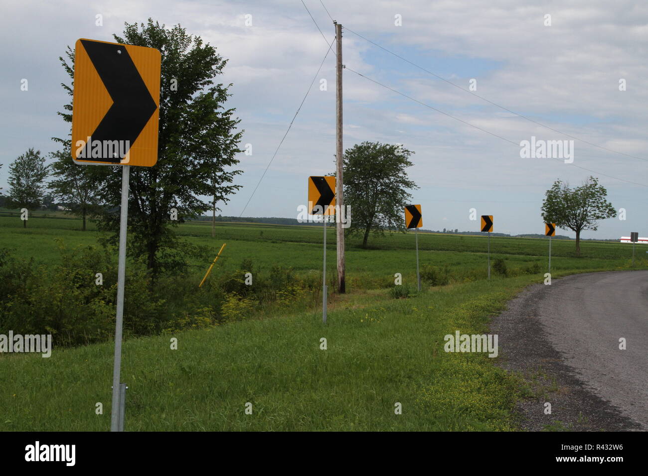 Signs showing winding curve on street Stock Photo - Alamy