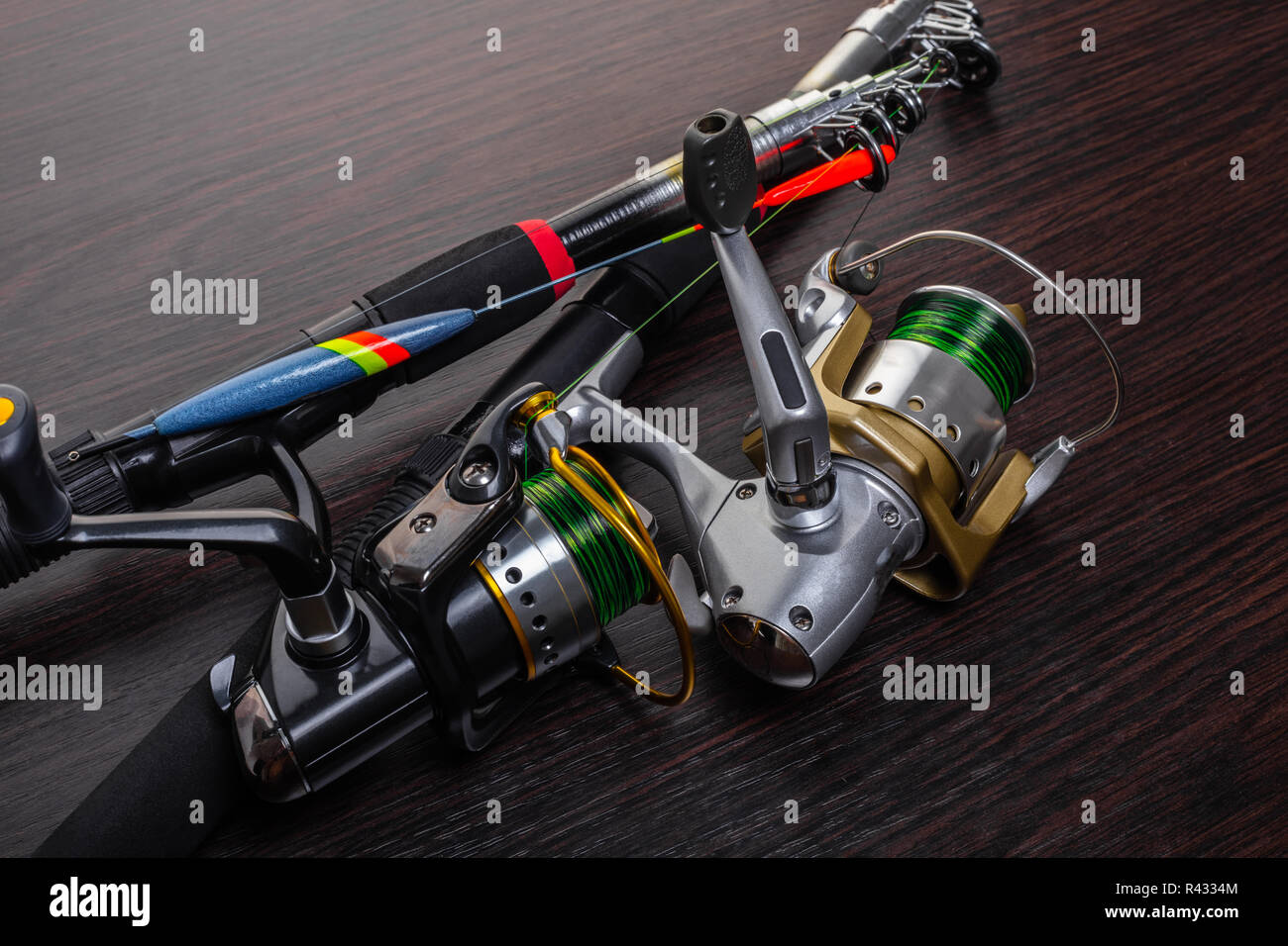 fishing rod with a coil on wooden background Stock Photo - Alamy