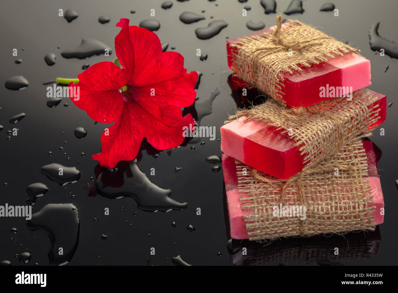 red flower soap handmade on a black background Stock Photo - Alamy