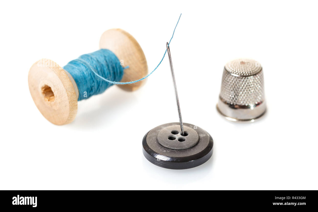spool of thread and buttons on white isolated background Stock Photo ...