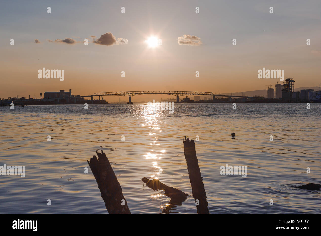 Traffic on bridge and sea crossing Mactan Bridge Cebu in misty dusk and ...
