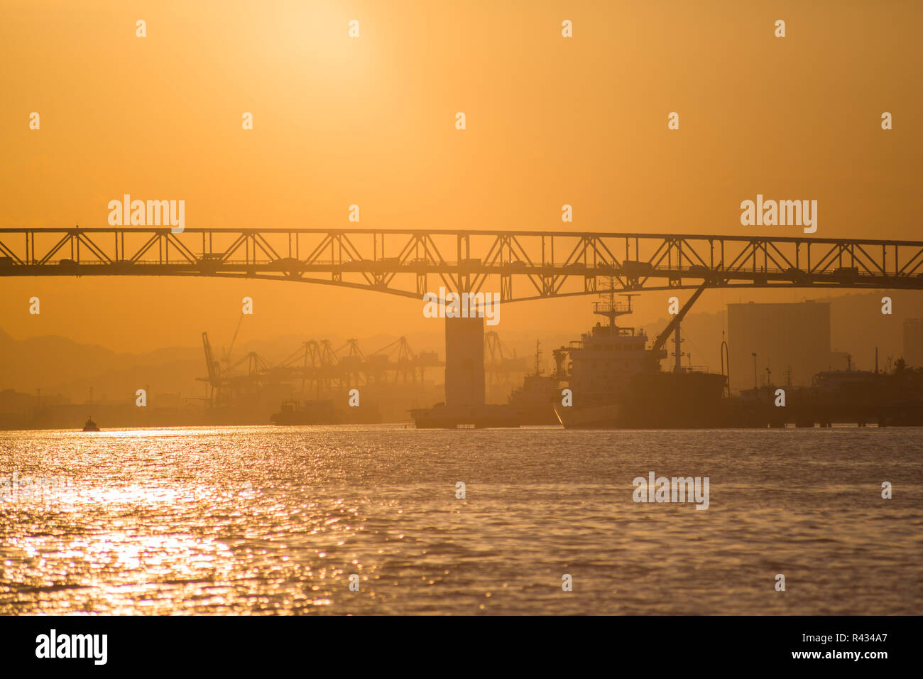 Traffic on bridge and sea crossing Mactan Bridge Cebu in misty dusk and ...