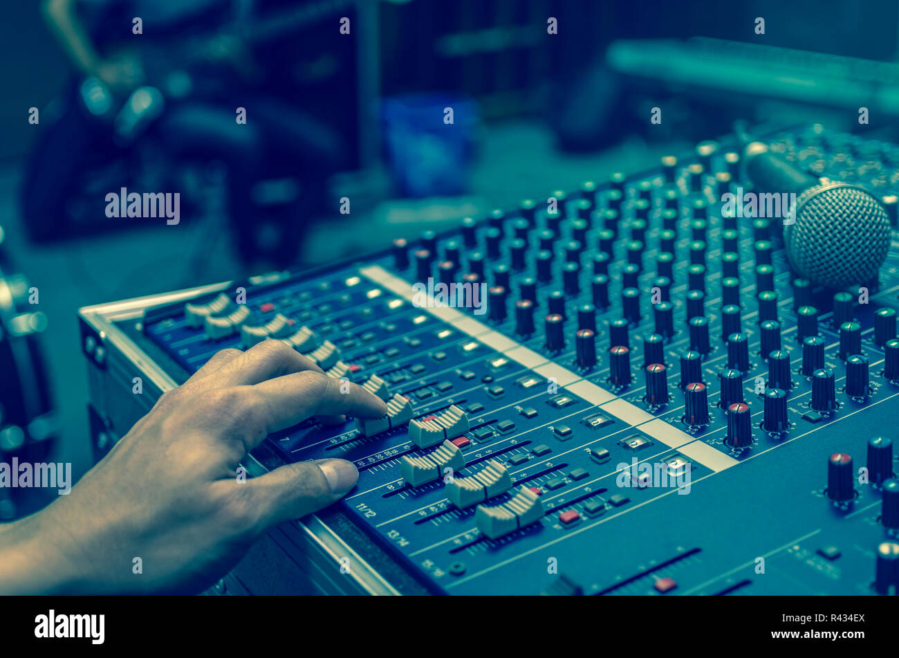 Hand adjusting audio mixer Stock Photo - Alamy