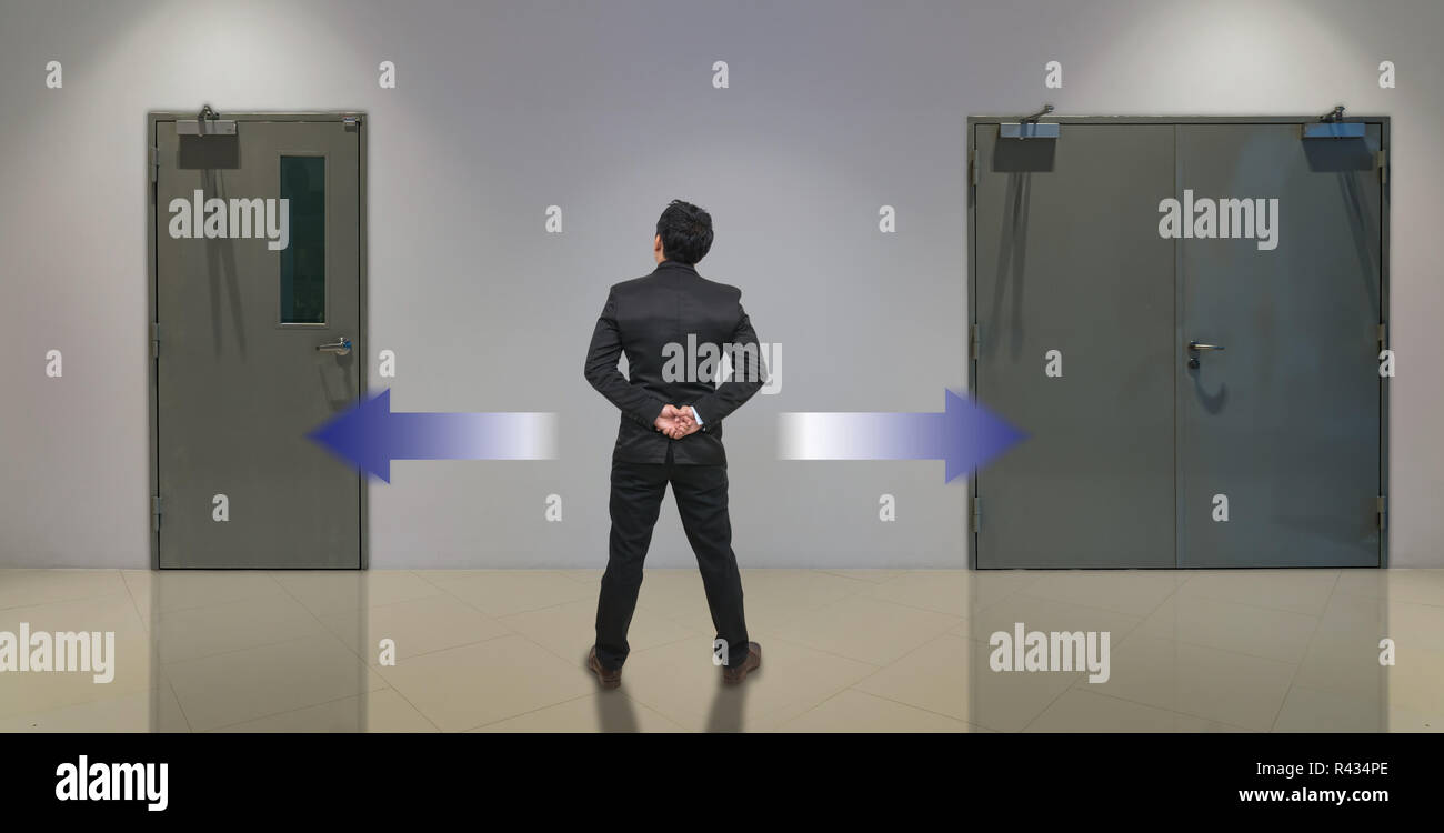 Businessman standing in doubt,thinking the two different choices ... Businessman standing in doubt,thinking the two different choices ...